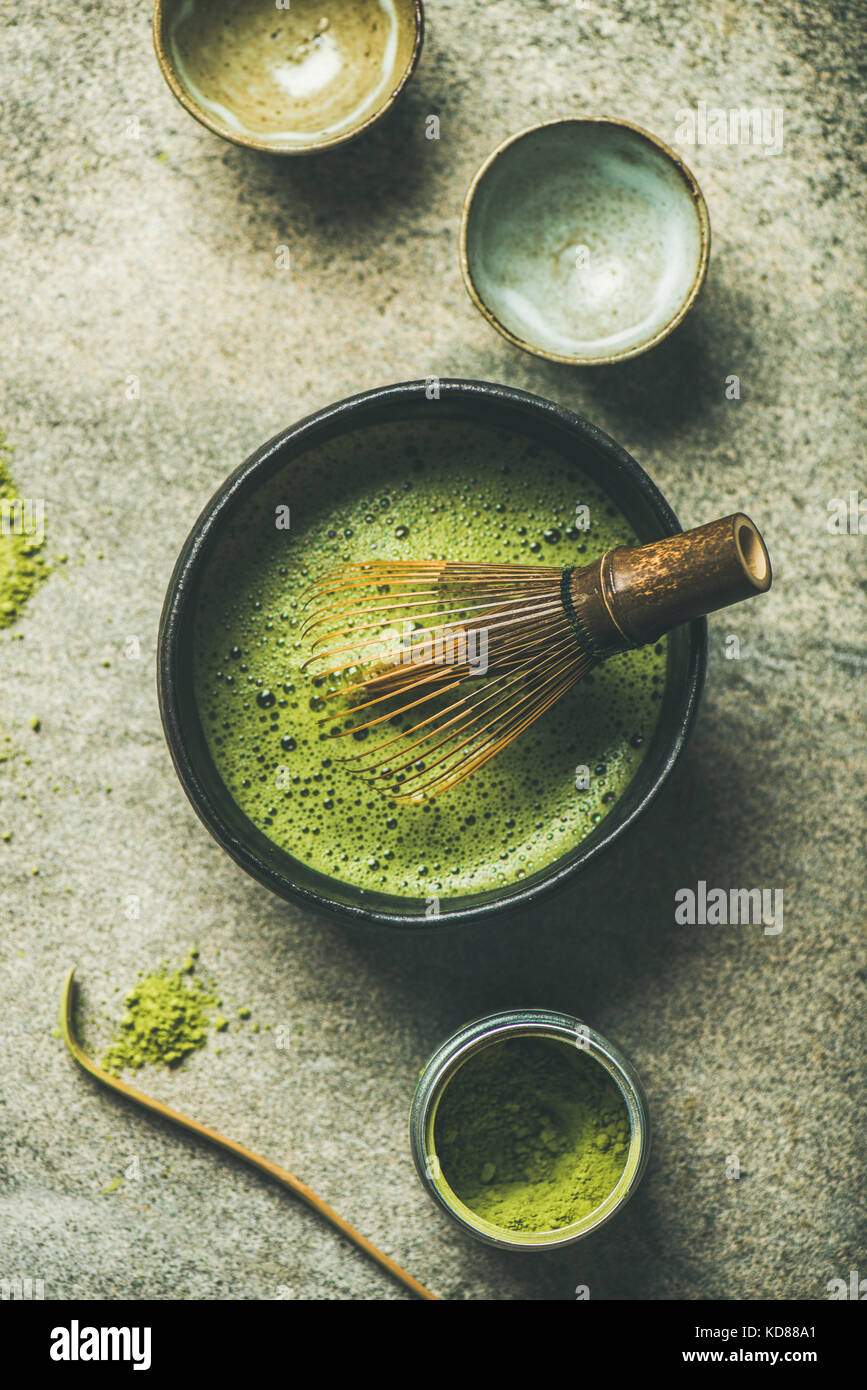 Flat-lay of Japanese tools for brewing matcha tea. Matcha powder in tin ...