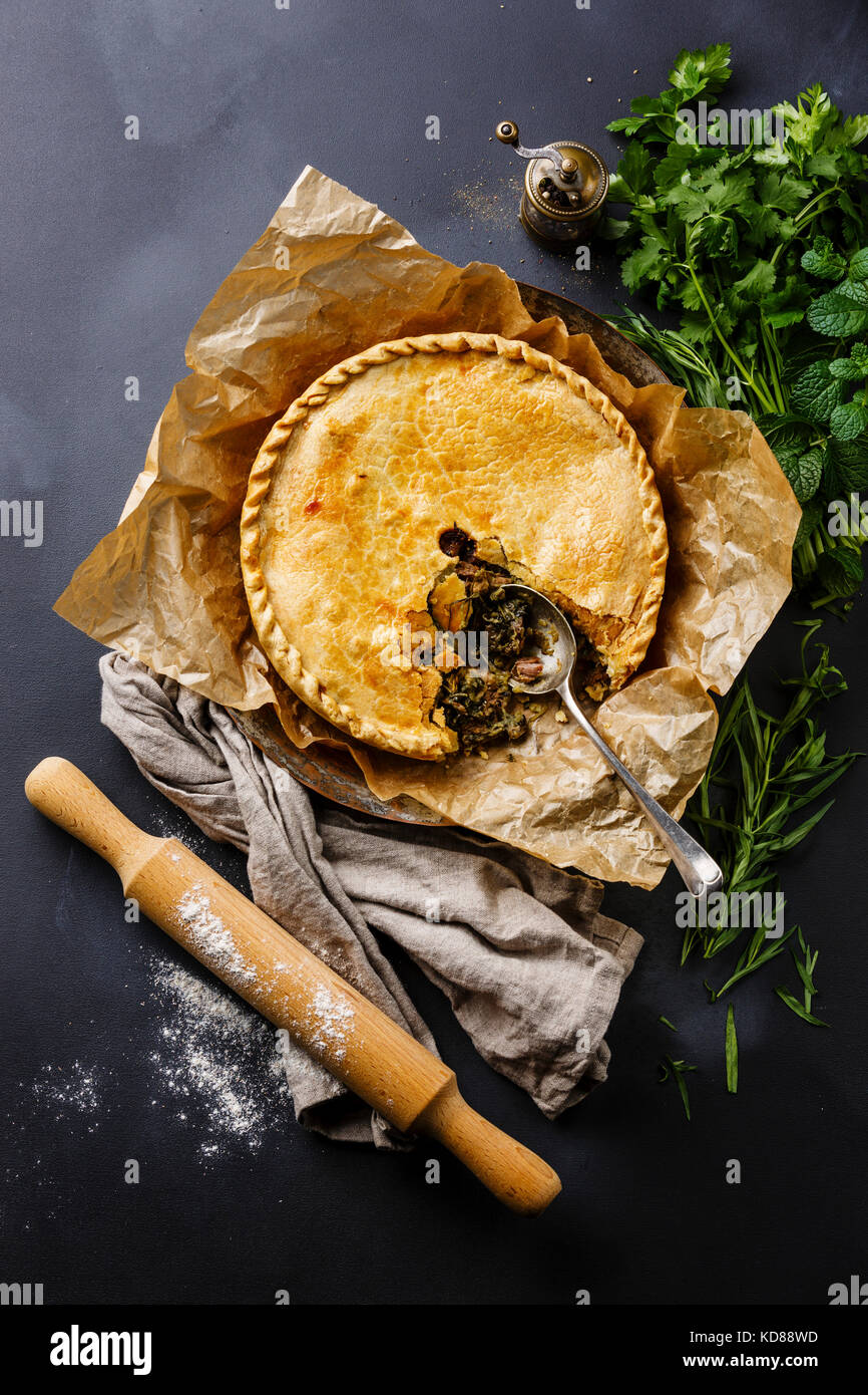 Meat Pie with herbs on blackboard slate background Stock Photo - Alamy