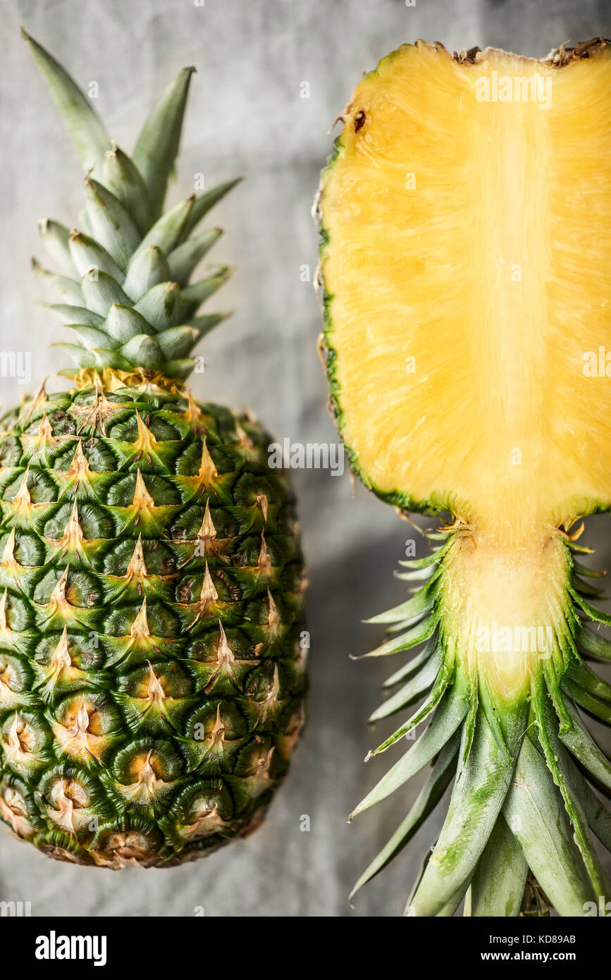 Whole pineapple split in half sitting on a natural linen Stock Photo ...