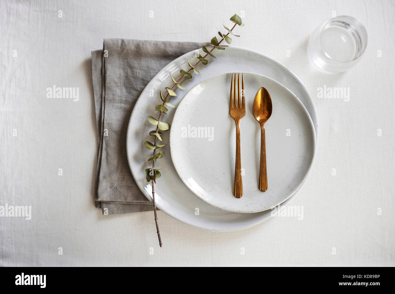 A beautiful, minimal table setting with organic, handmade gray plates ...
