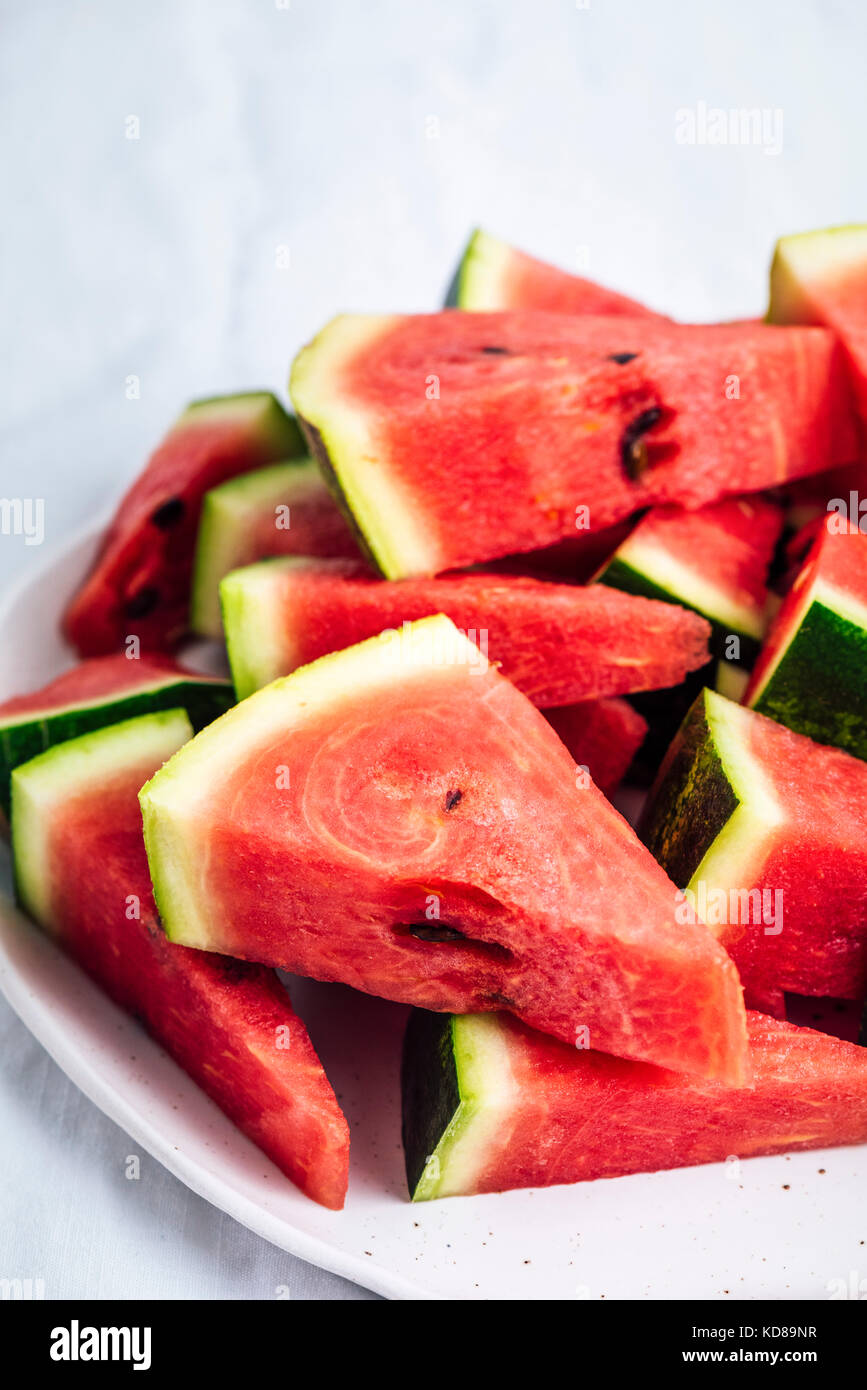 Mini watermelon slices in triangle shape are piled on a plate Stock ...