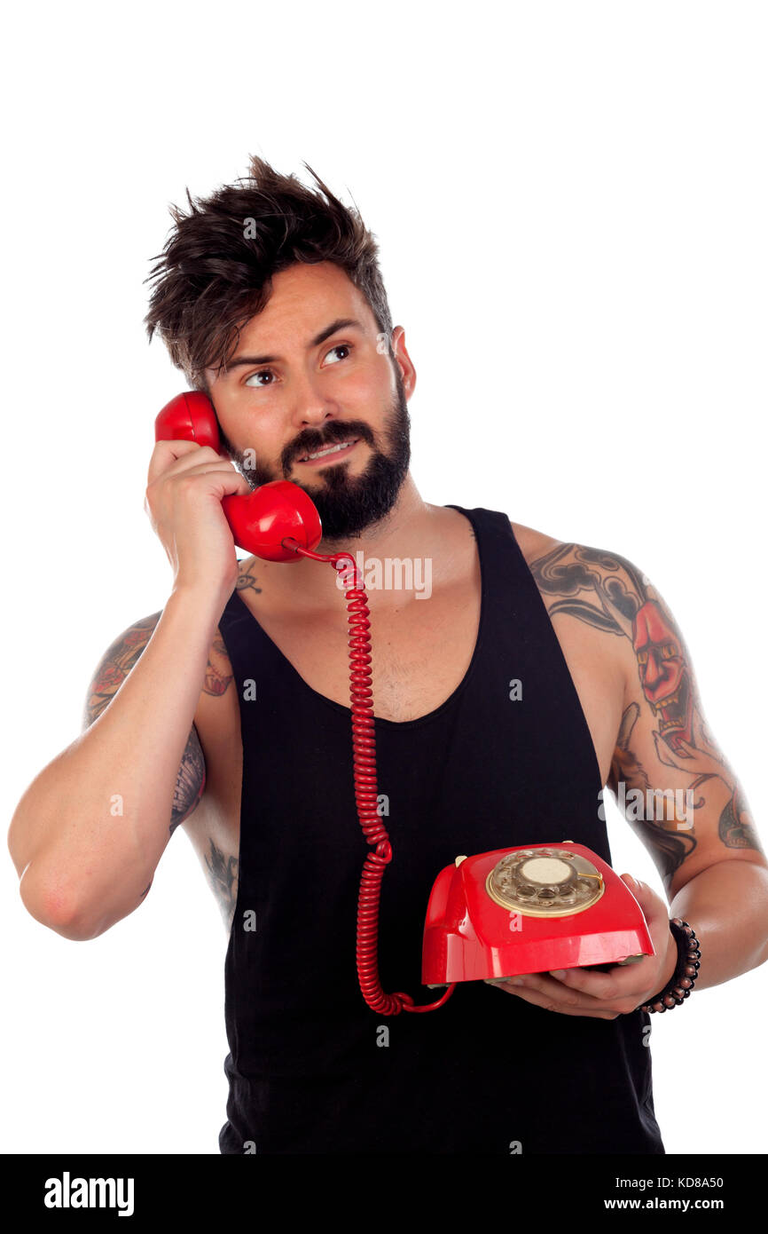 Attractive guy with a old red phone isolated on a white background ...