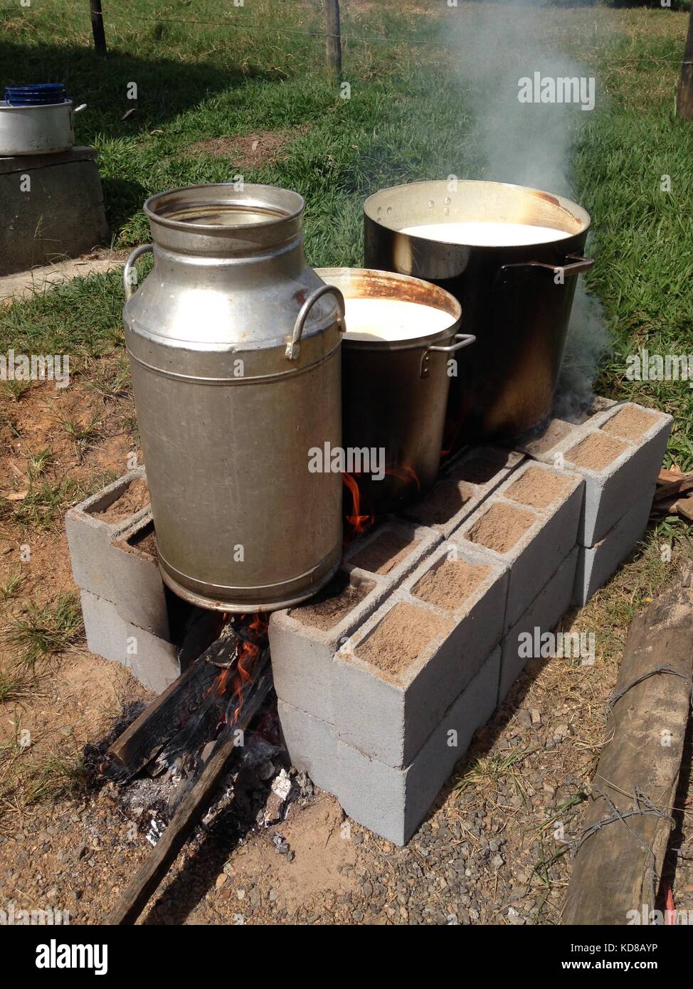 Cheesemaking in a rustic farm, warming up milk over open fire Stock ...