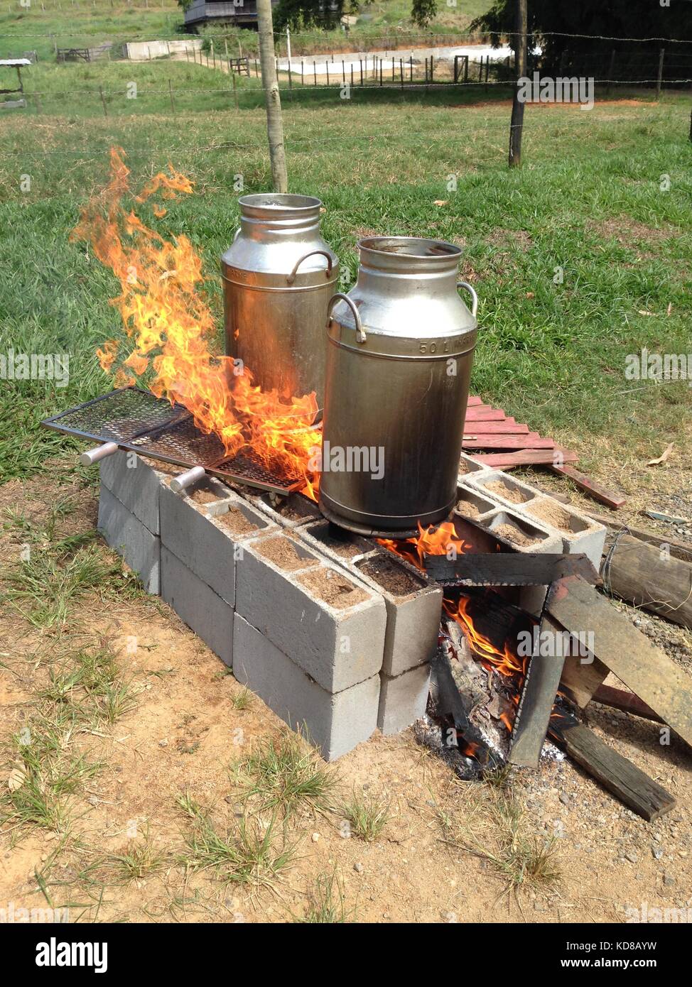 Cheesemaking in a rustic farm, warming up milk over open fire Stock ...