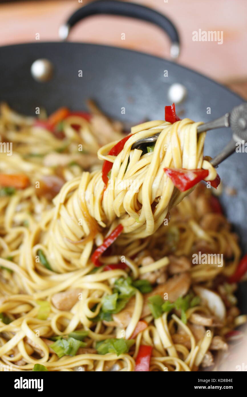 Vegetable noodle dish in wok ready to serve, with noodle rolled around ...