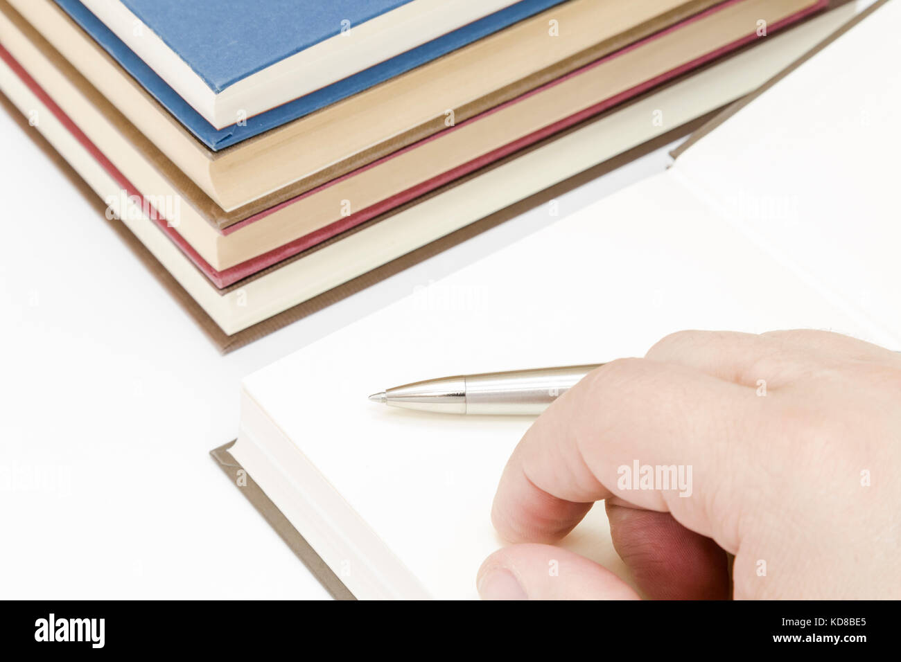 a person beginning to write on a blank book Stock Photo - Alamy