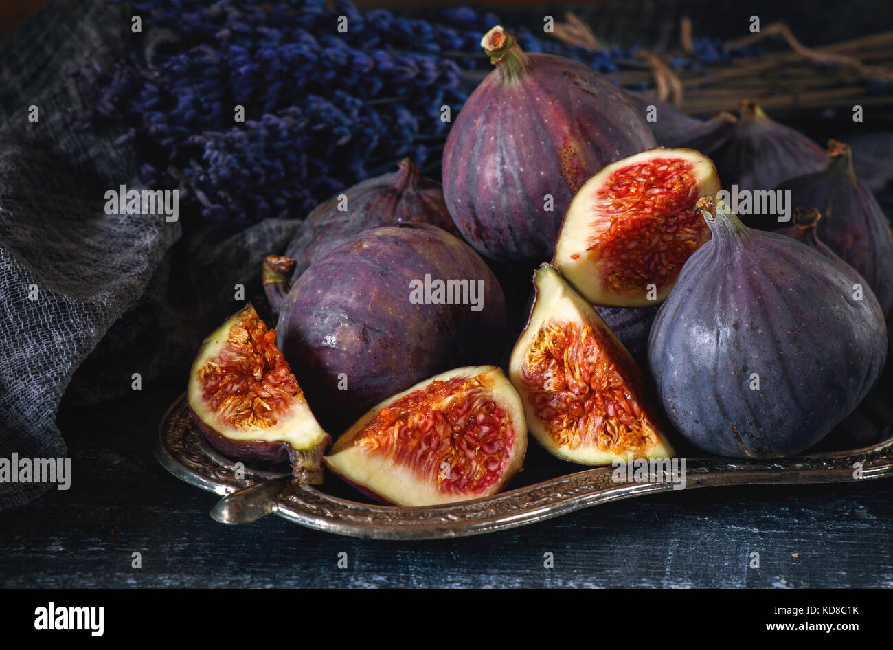 Sweet red ripe figs on a bunch of lies on a beautiful metal stand Stock ...