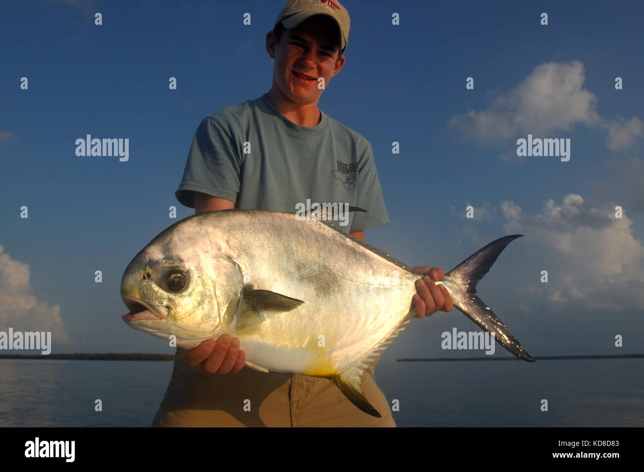 Fisherman with a permit caught while fly fishing in the Florida Keys ...