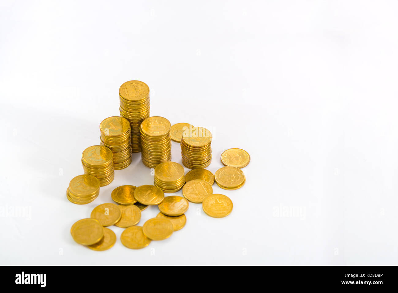 Columns of gold coins, piles of coins arranged on white background ...