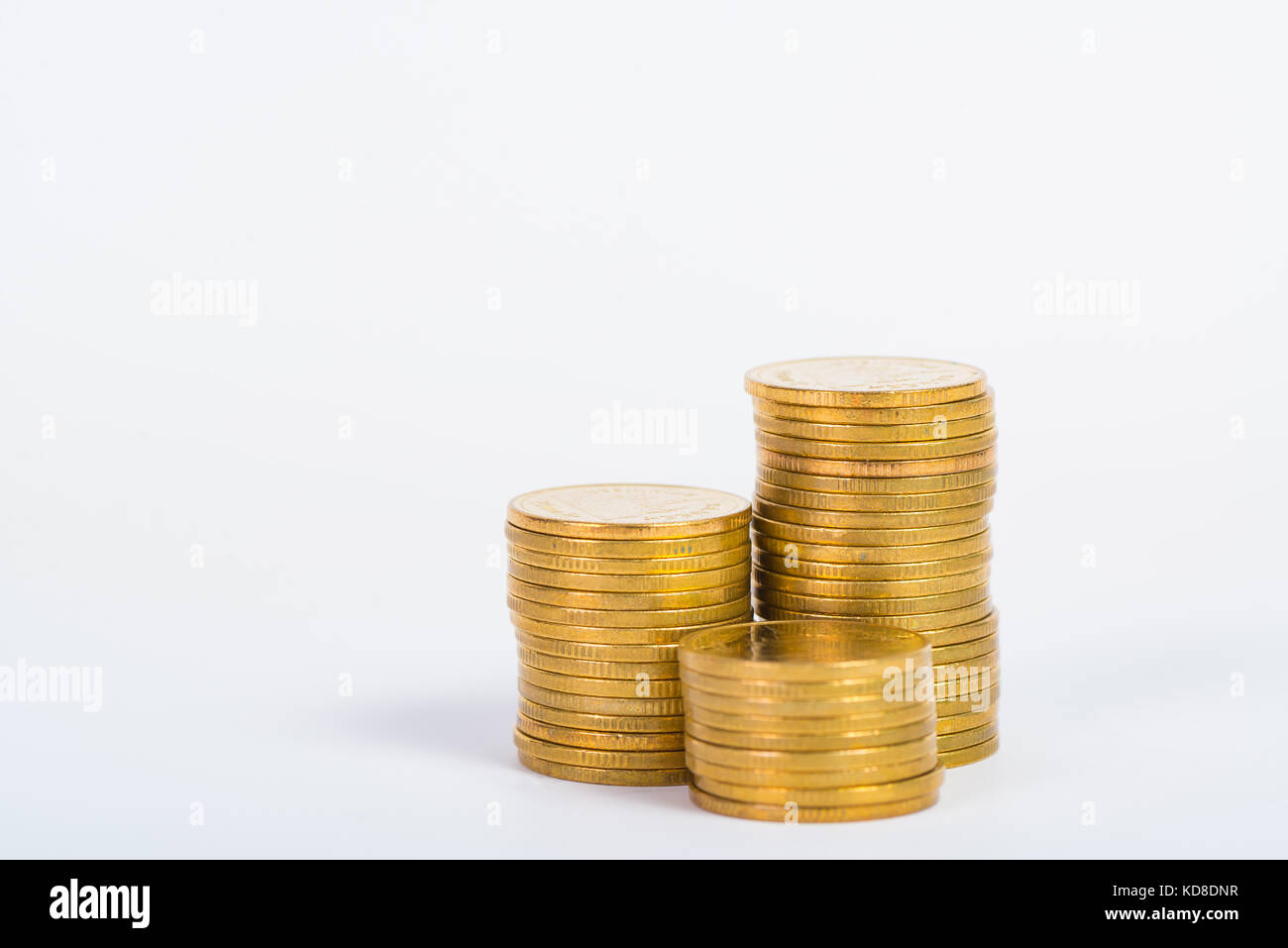 Columns of gold coins, piles of coins arranged on white background ...