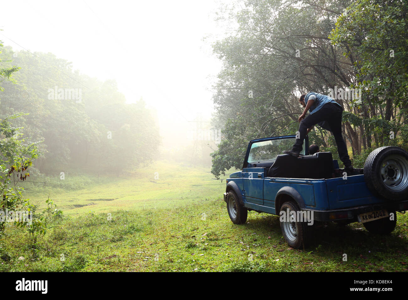 Close up blue old Jeep car parking on the India.man jumping outside at ...