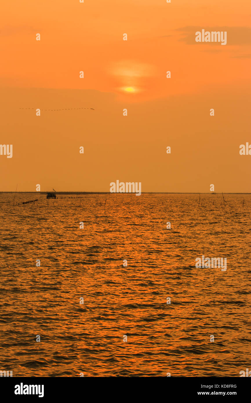 sunset above sea with oyster house Stock Photo - Alamy