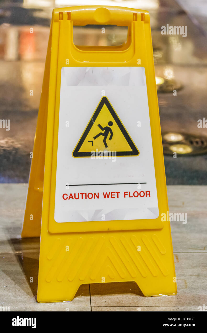 caution wet floor sign at a sidewalk Stock Photo - Alamy