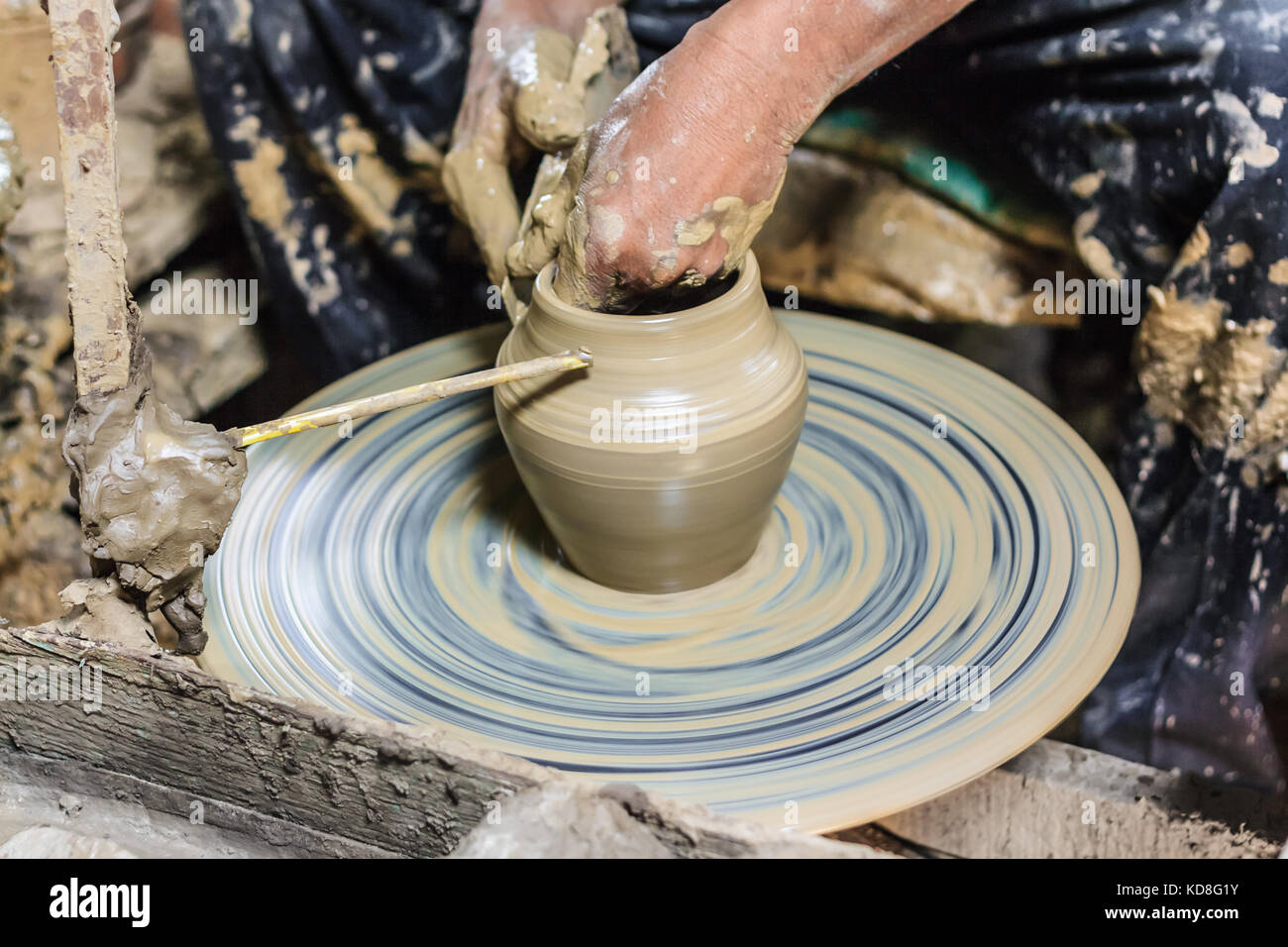 dirty hands making pottery in clay on wheel Stock Photo - Alamy