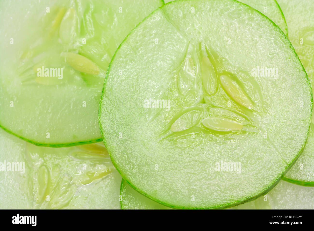 close up fresh green sliced cucumber whole background Stock Photo - Alamy