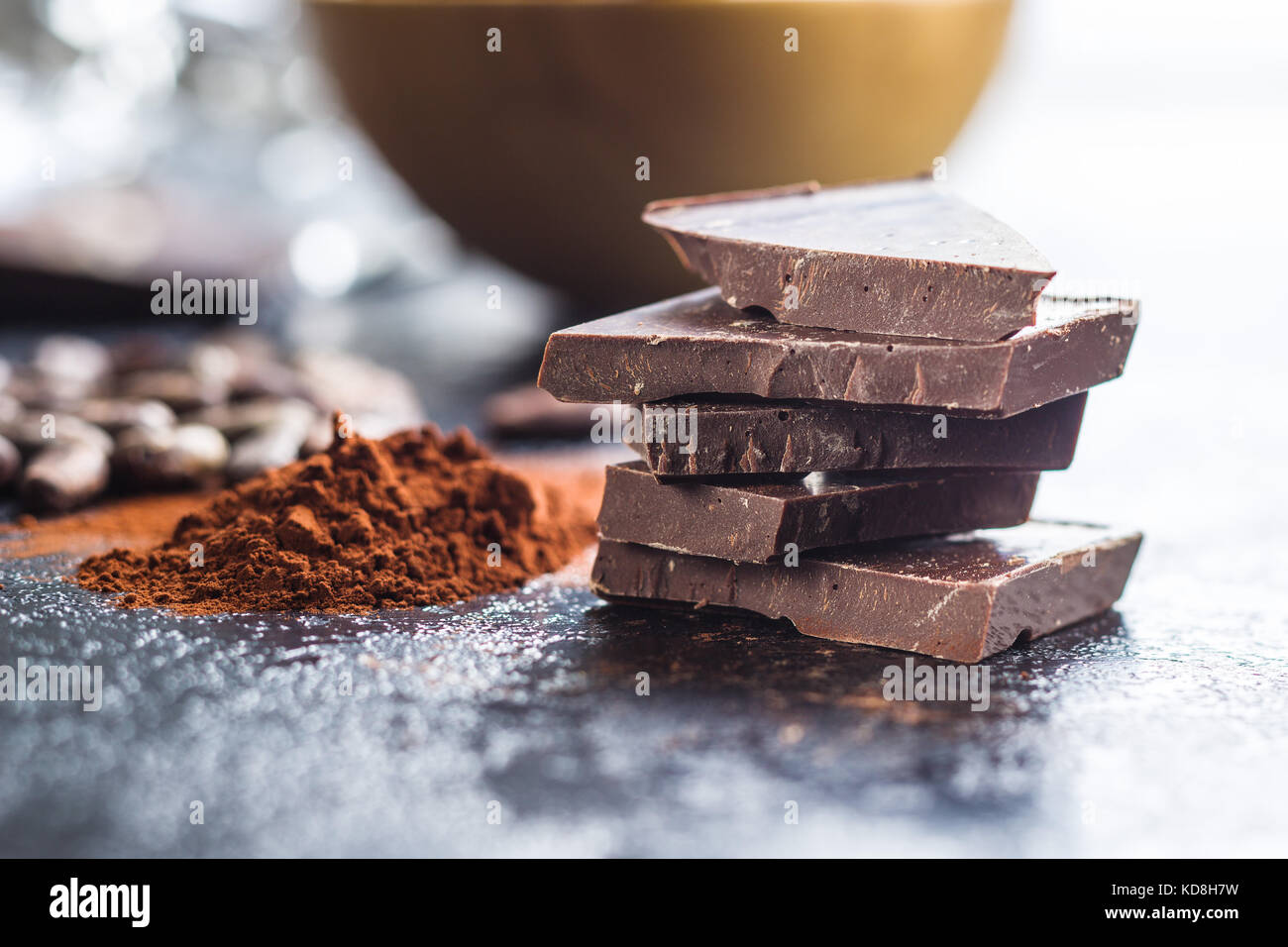 Dark cocoa powder and chocolate on old kitchen table Stock Photo - Alamy