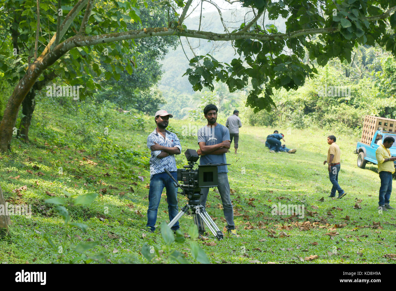 Camera man and camera operator looking on outside, film shooting spot ...