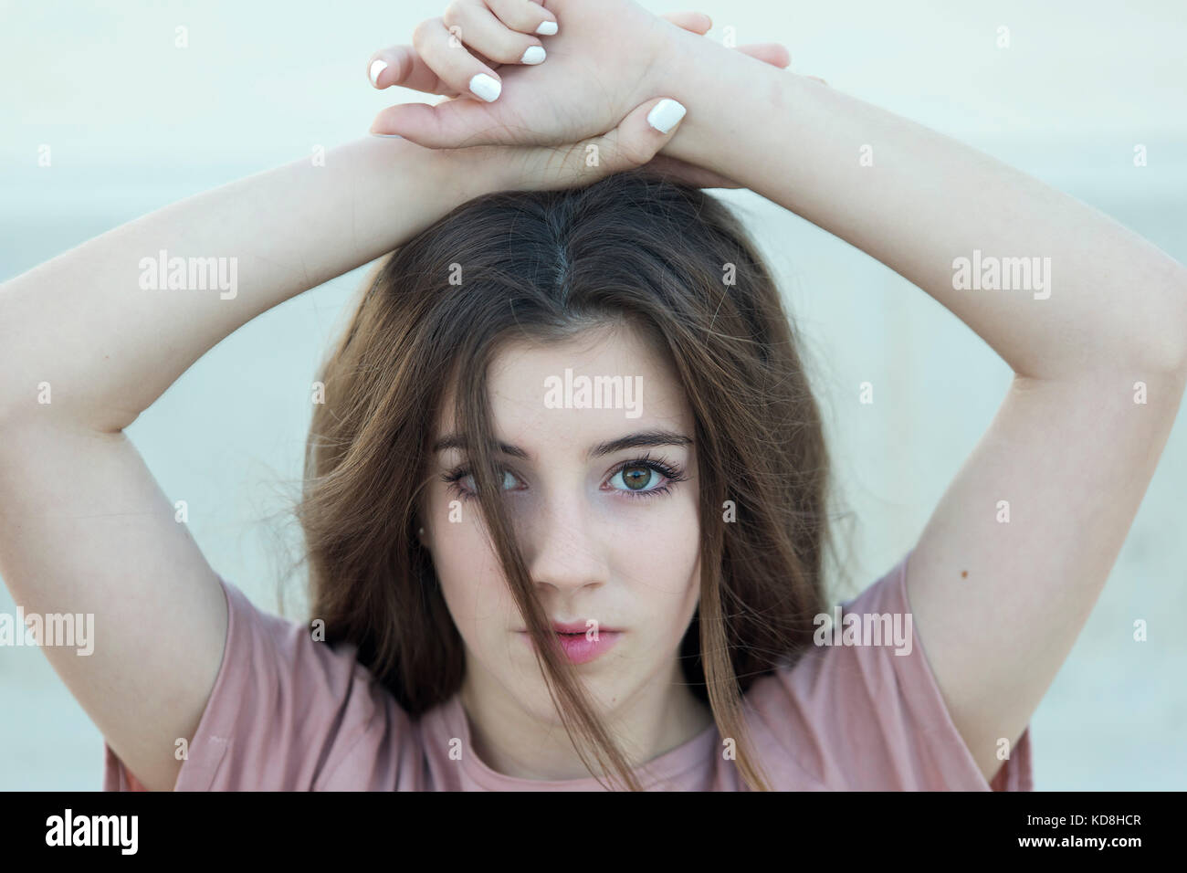 Portrait of a teenage girl with arms over head. Horizontal format with ...