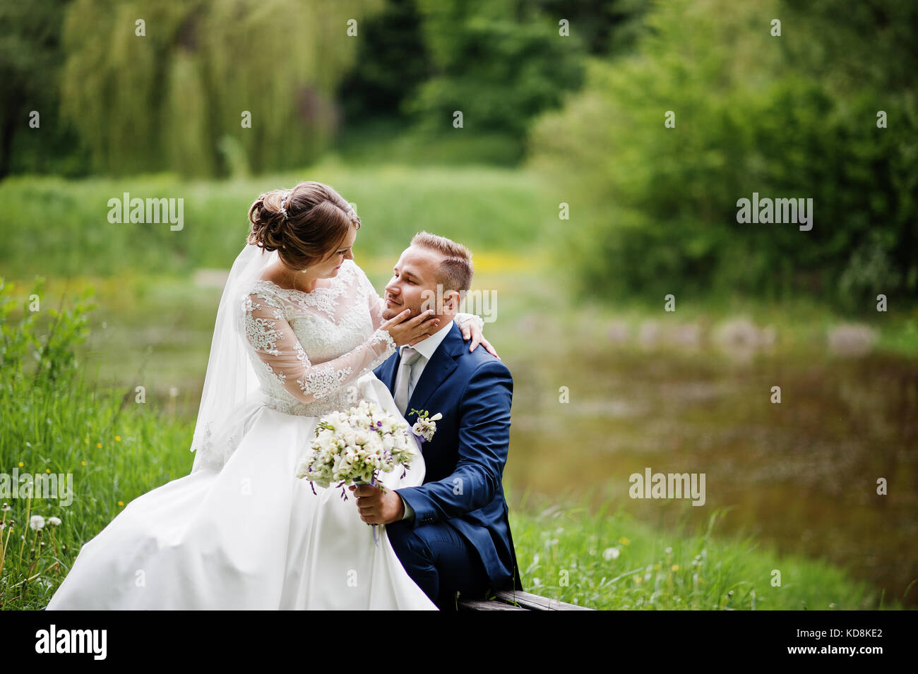 Bride sitting on lap groom hi-res stock photography and images - Alamy
