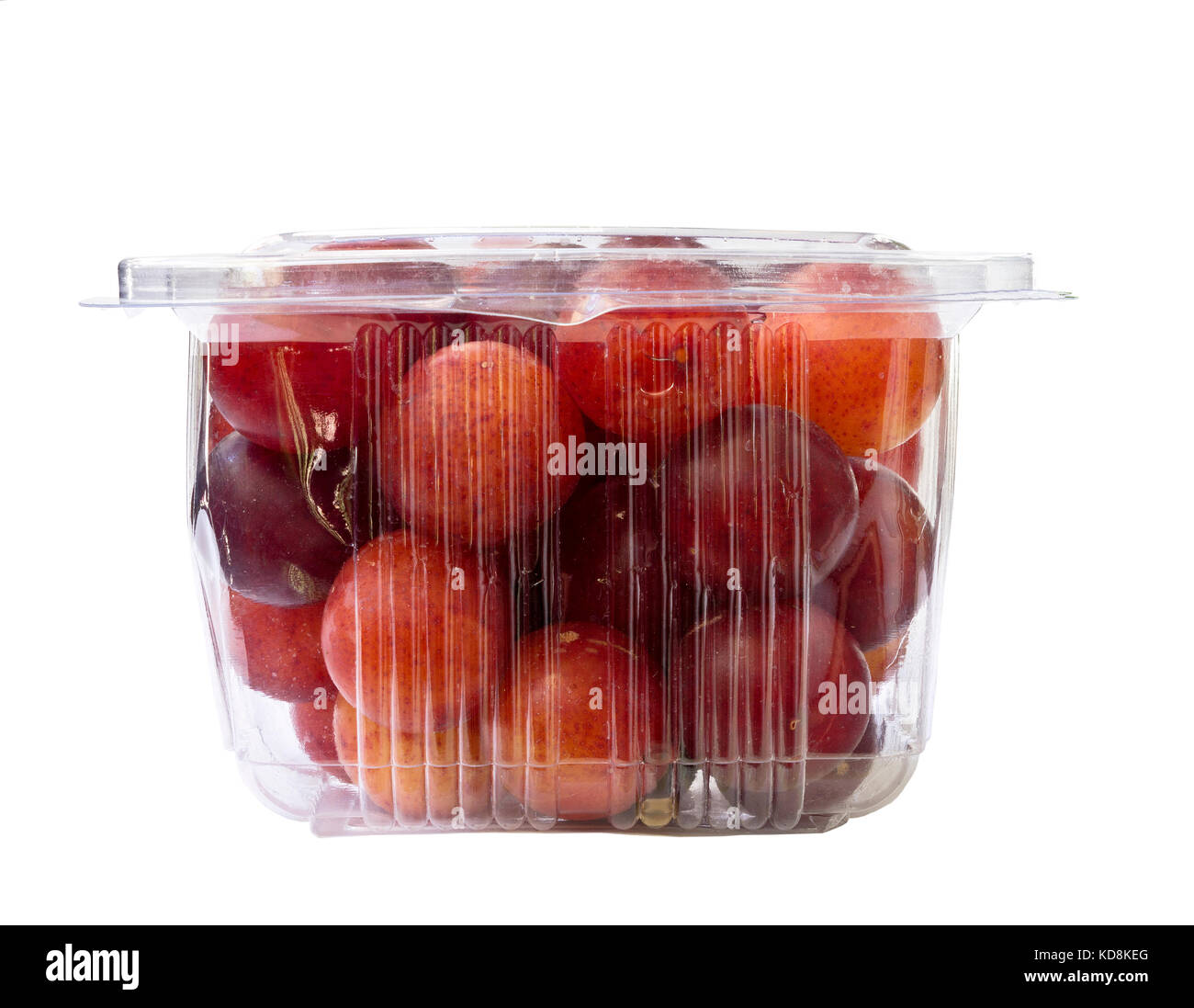Fresh plums in transparent plastic package. Isolated on a white ...