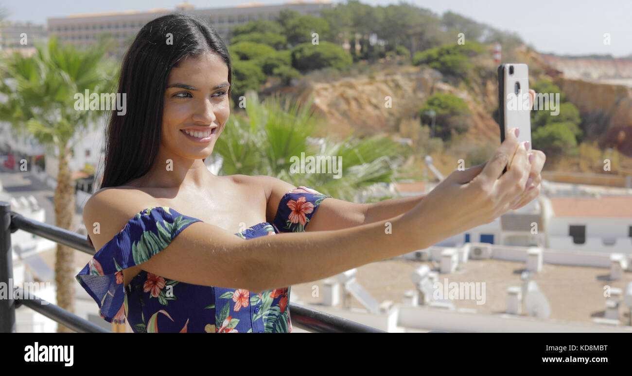 Confident model taking selfie on resort Stock Photo - Alamy