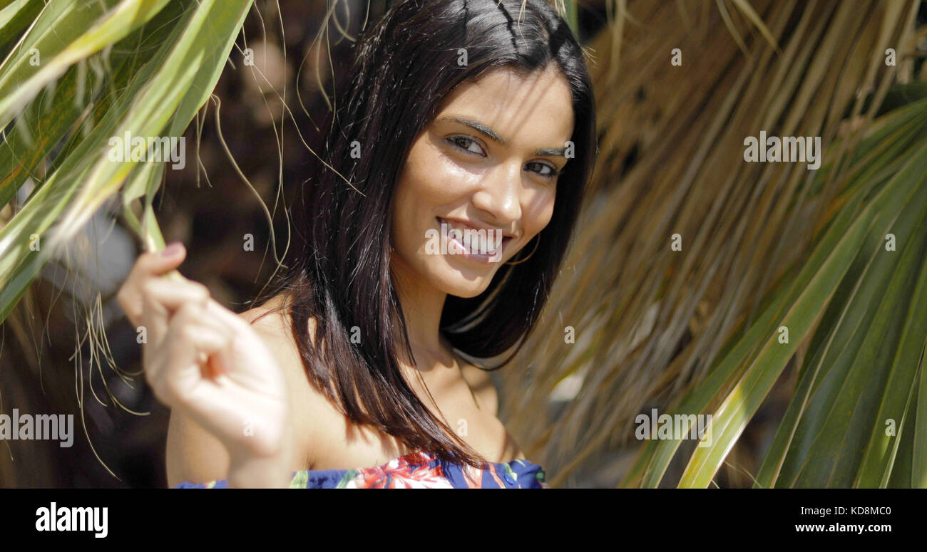 Charming model posing in palms Stock Photo - Alamy