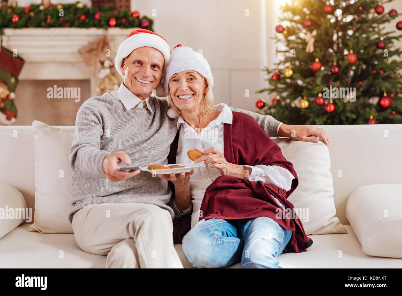 Positive delighted people eating cookies Stock Photo - Alamy