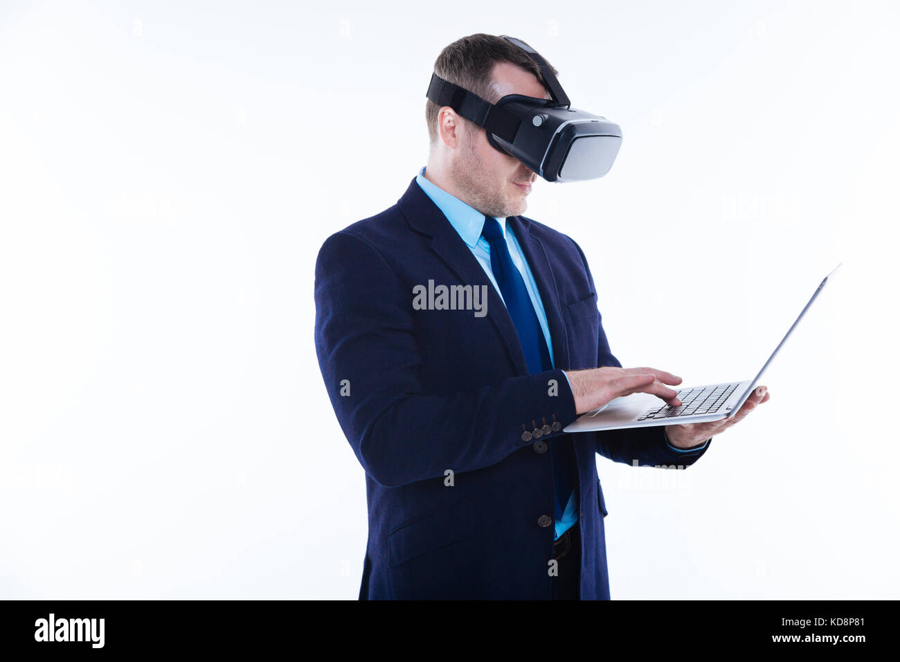 Smart positive man using a laptop Stock Photo - Alamy