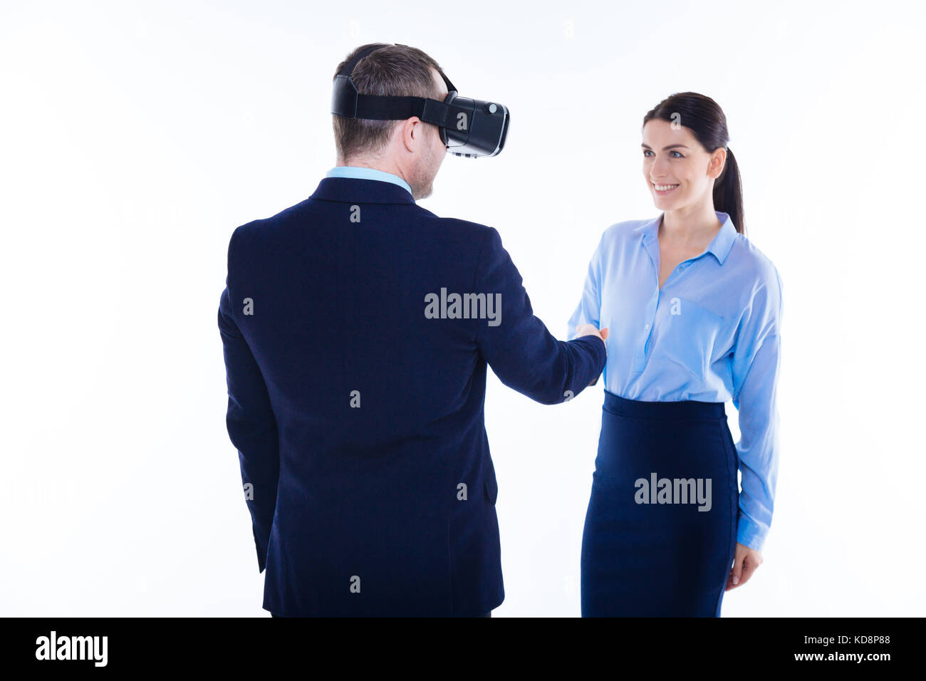 Nice friendly man greeting his colleague Stock Photo - Alamy