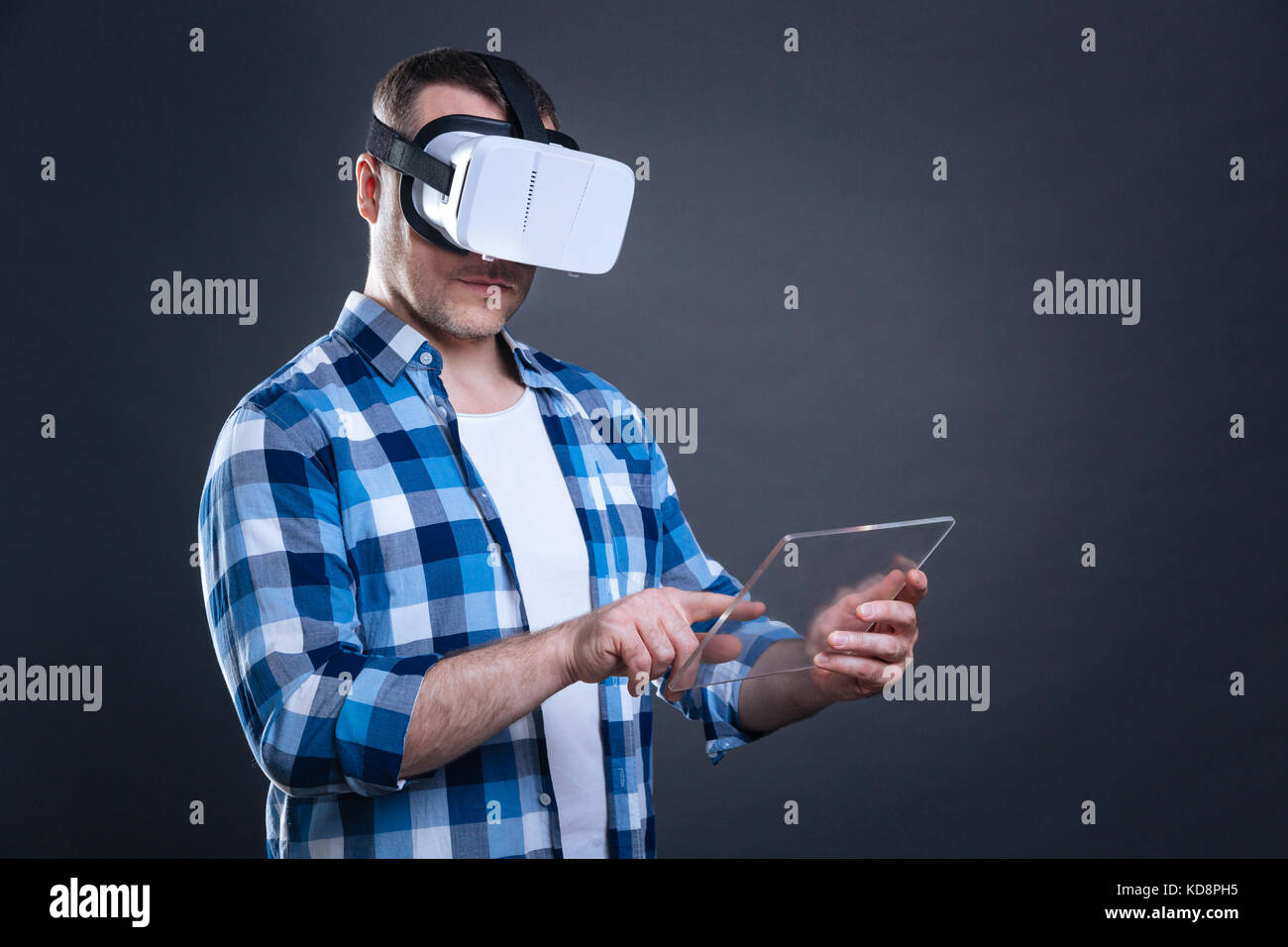 Smart handsome man using a digital device Stock Photo - Alamy