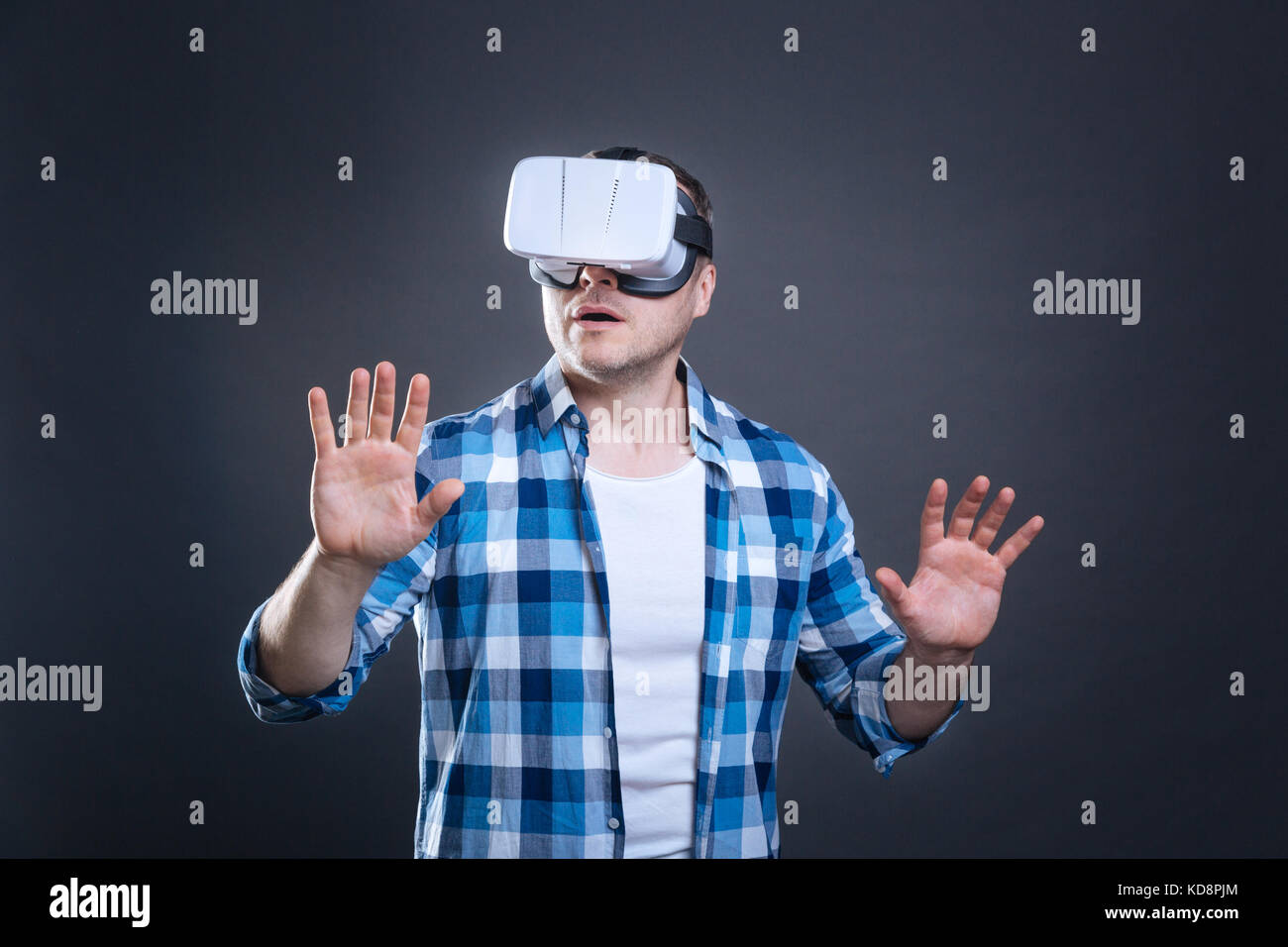 Smart handsome man looking at his fingers Stock Photo - Alamy