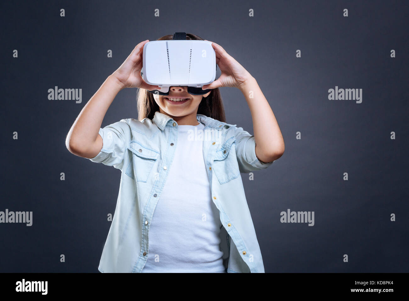 Cheerful happy girl enjoying modern technology Stock Photo - Alamy