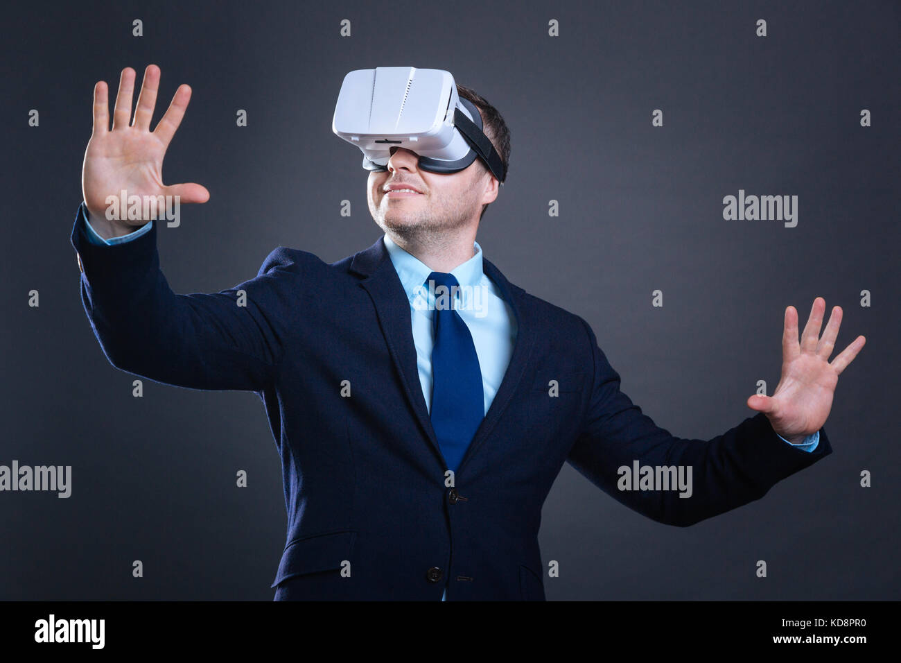 Cheerful smart businessman enjoying new technologies Stock Photo - Alamy