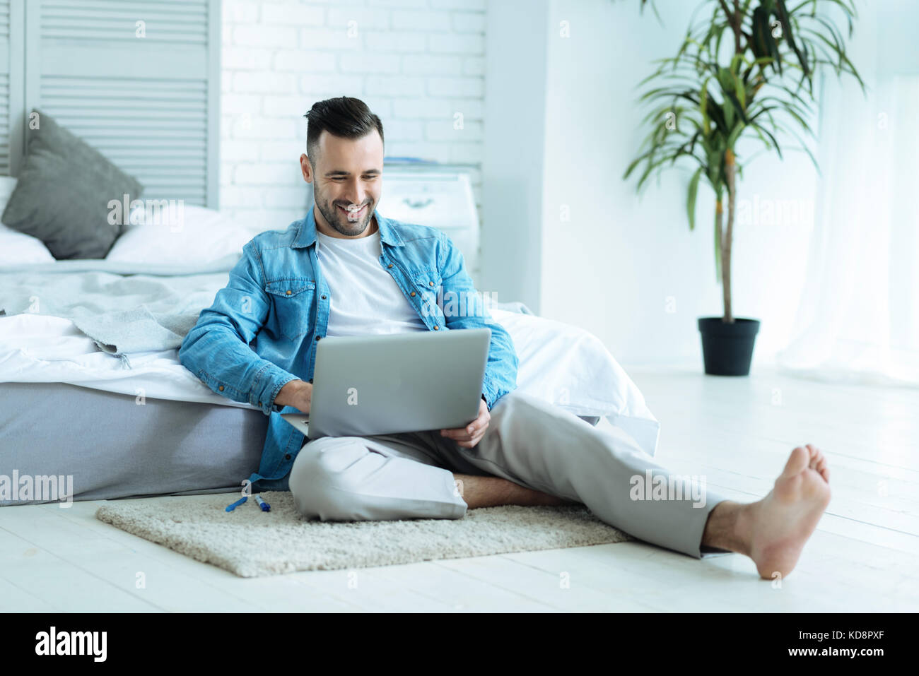 Happy self employed man smiling while working from home Stock Photo - Alamy
