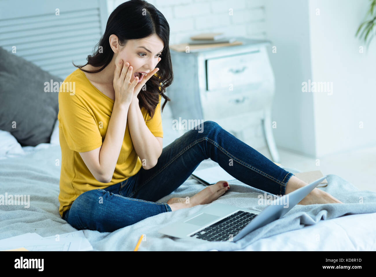 Amazed girl reacting to positive news during video call Stock Photo - Alamy