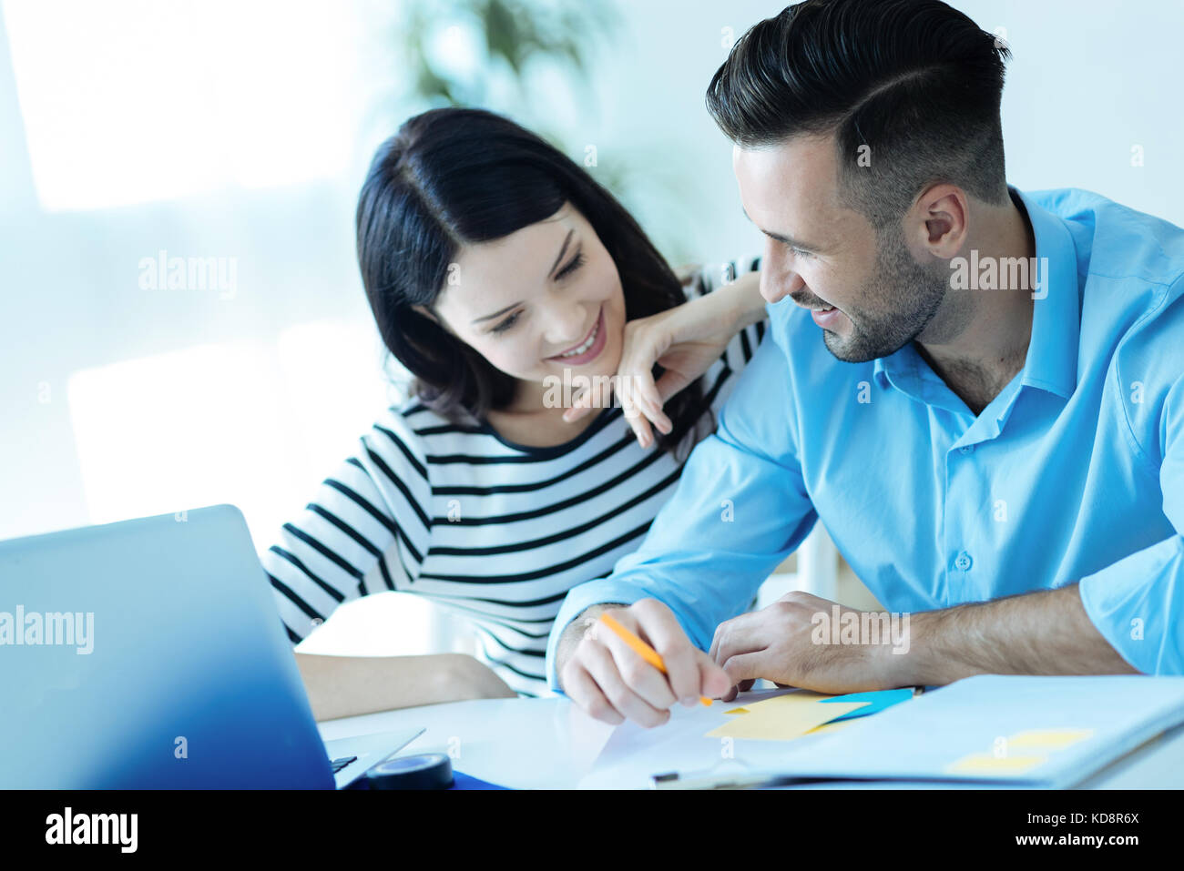 Friendly office employees working together Stock Photo - Alamy