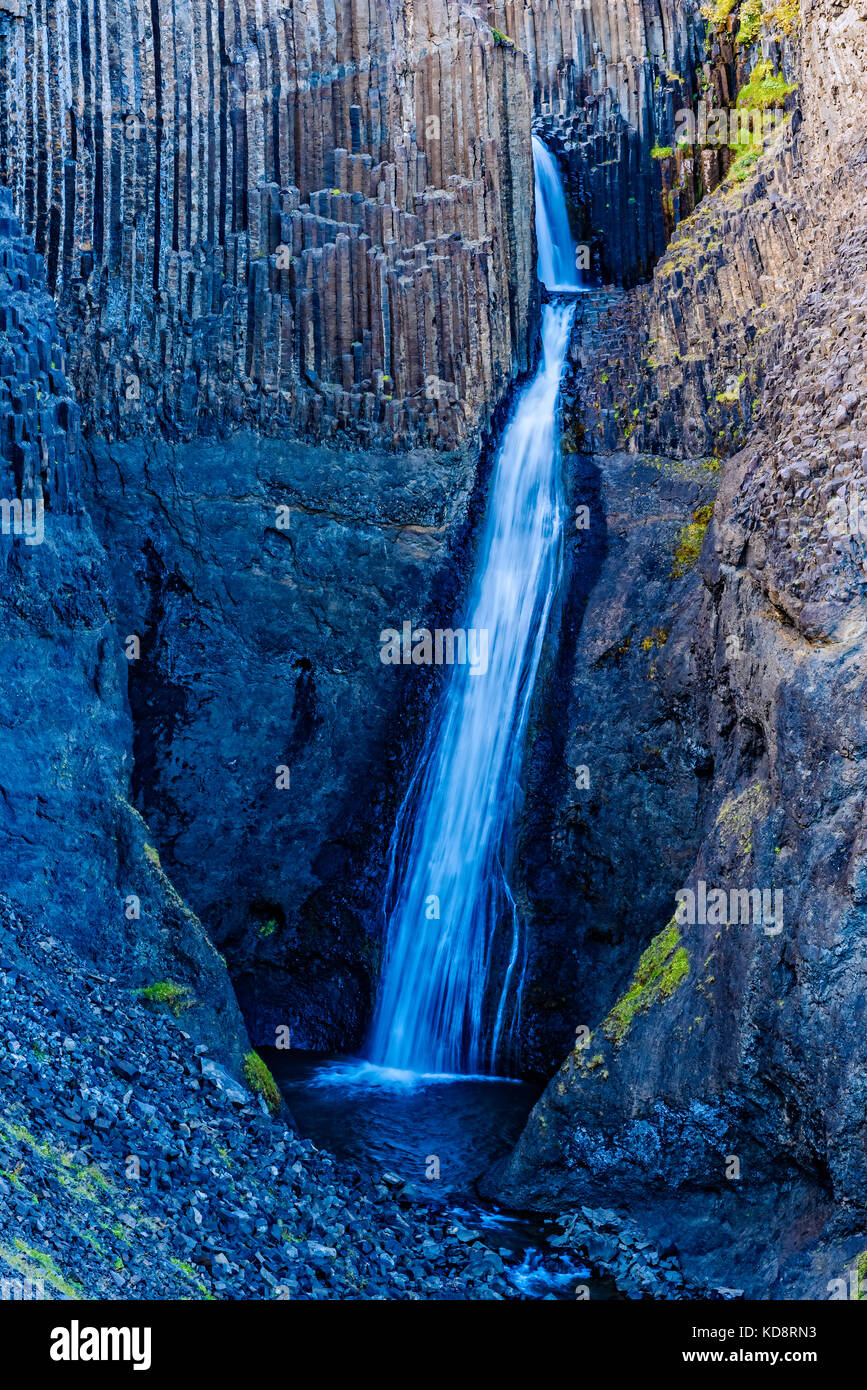 Litlanesfoss waterfall in Iceland with surrounding basalt columns Stock ...