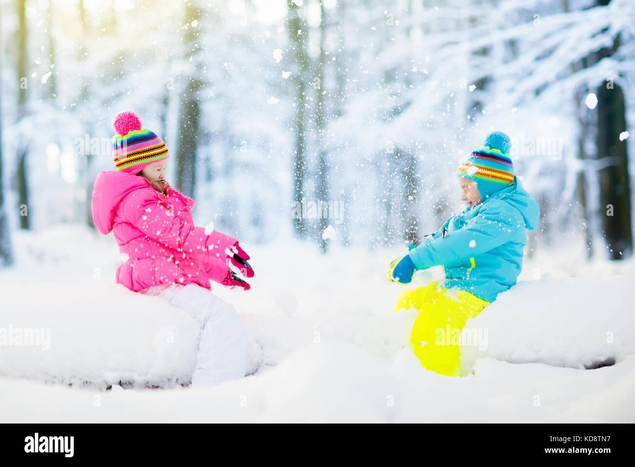 Kids playing in snow. Children play outdoors on snowy winter day. Boy ...