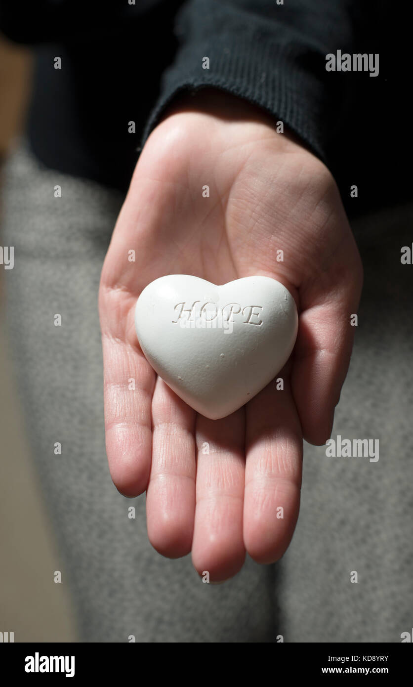 Woman hold in hands heart. Help concept and expectation Stock Photo - Alamy