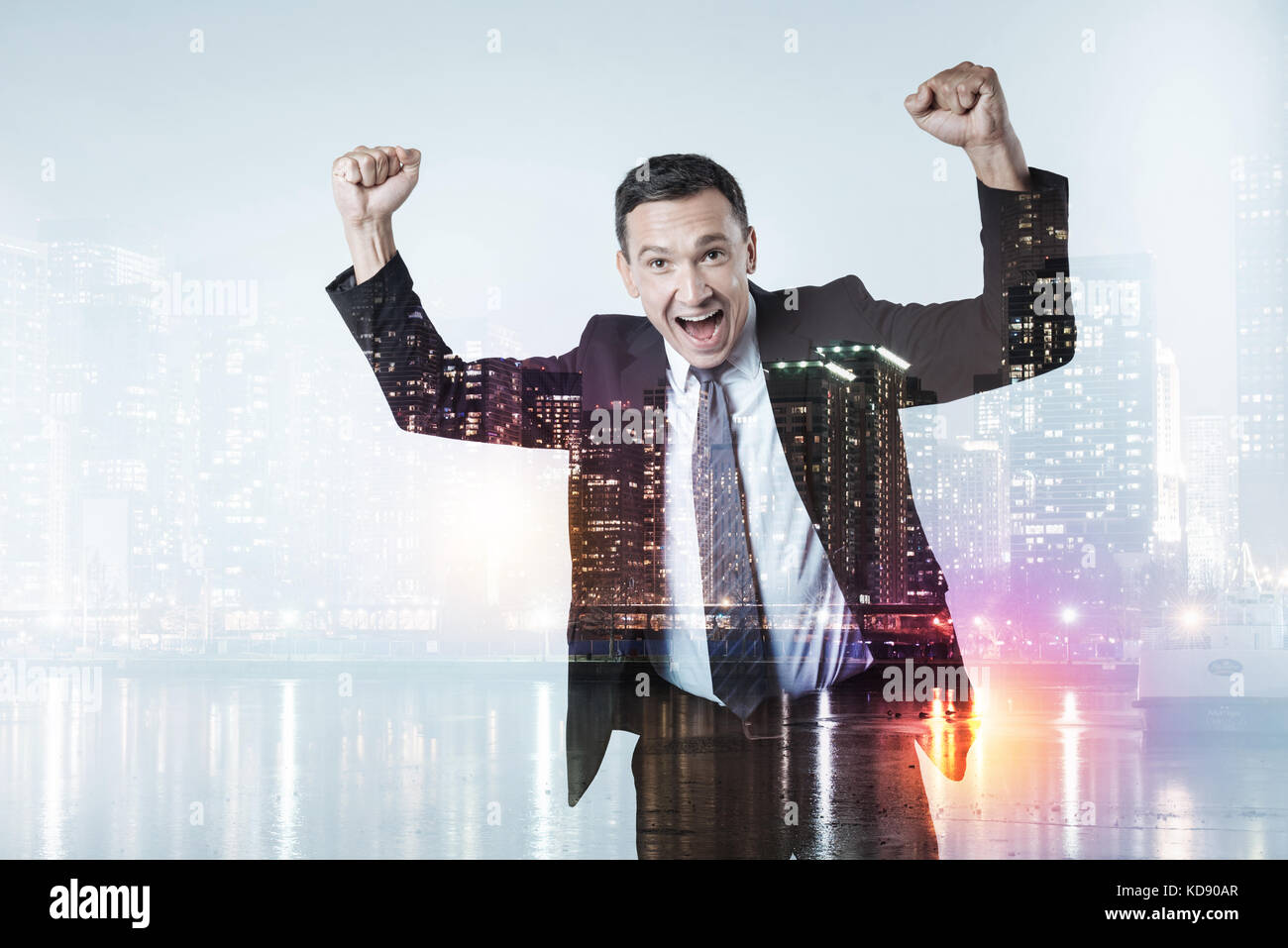 Happy businessman raising fists up Stock Photo - Alamy