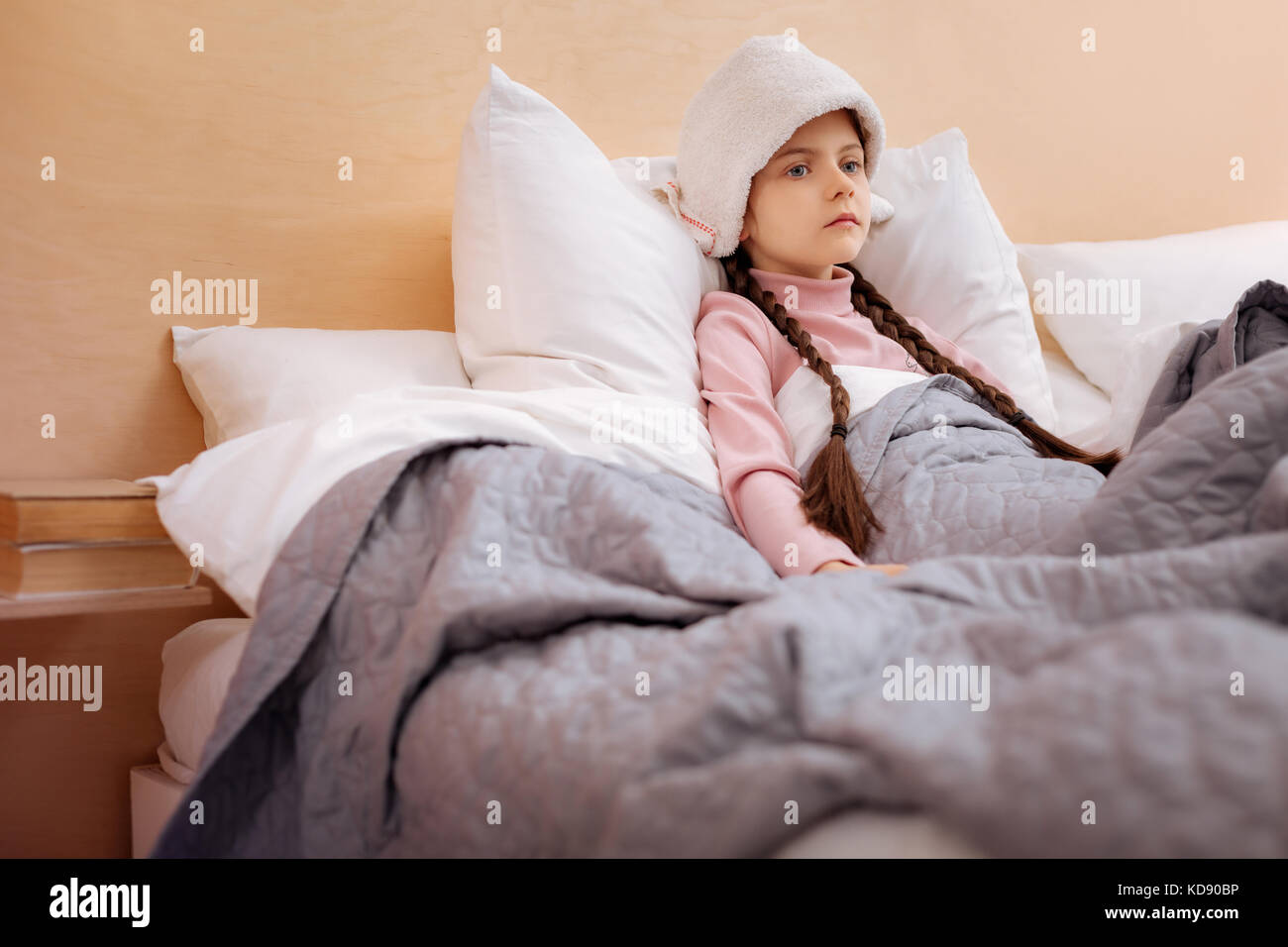 Sad girl sitting with a towel on her head Stock Photo - Alamy