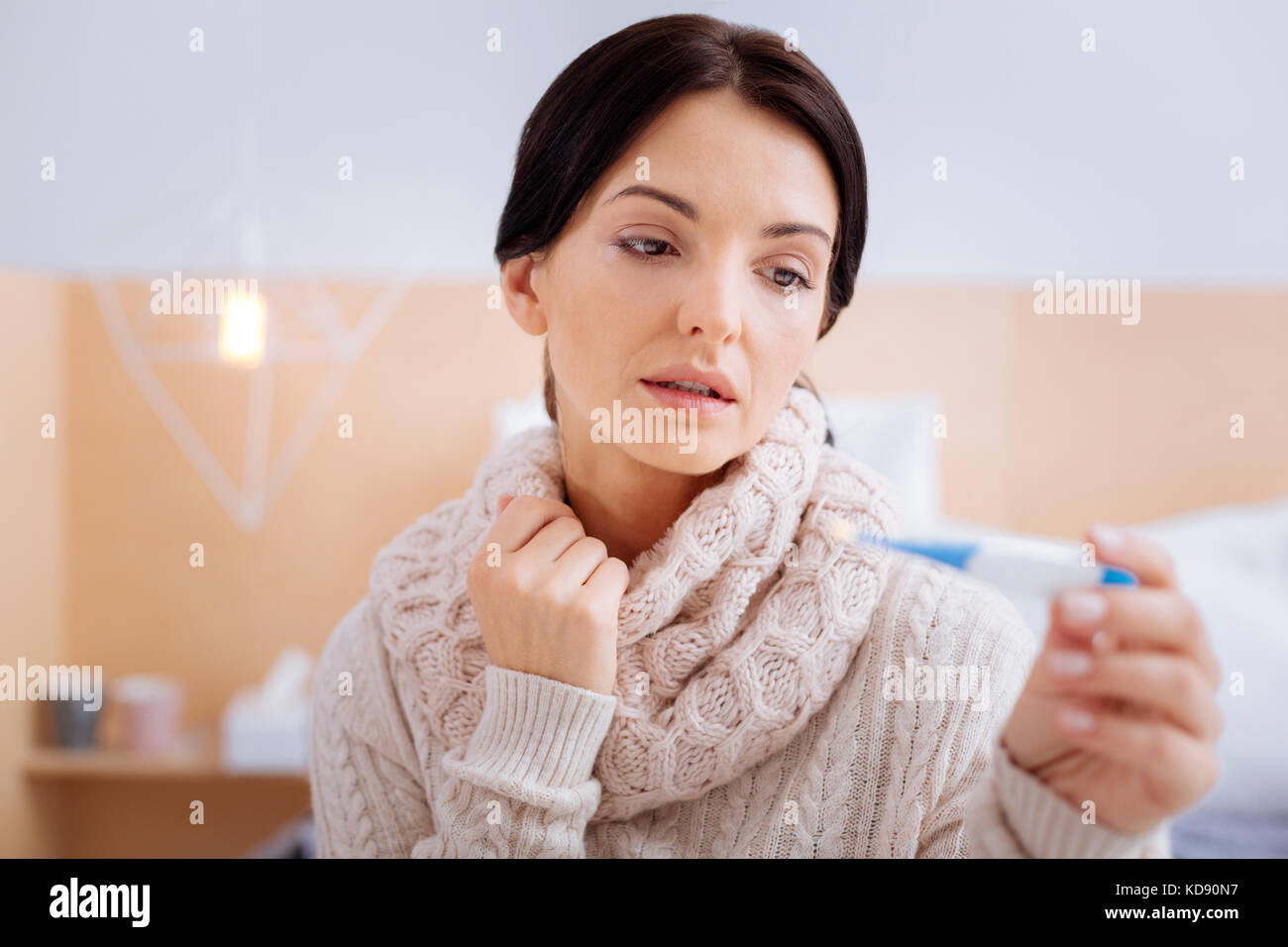 Young woman thinking about her high temperature Stock Photo - Alamy