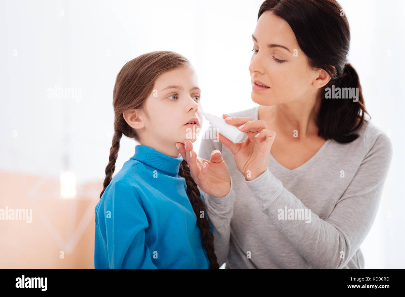 Loving mother curing a running nose of her kid Stock Photo - Alamy