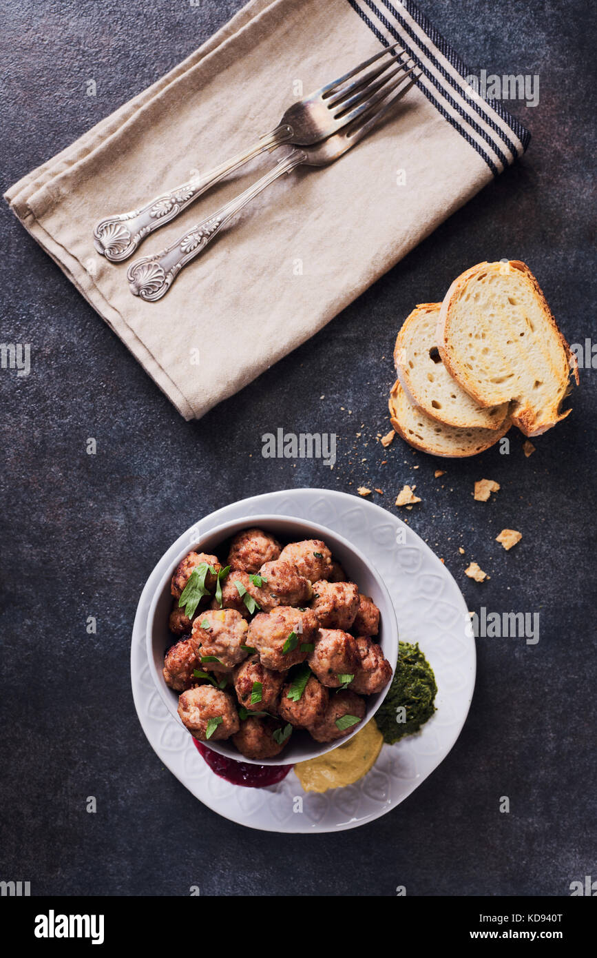Meatballs in a cup with various sauces on a plate, grey colors Stock ...