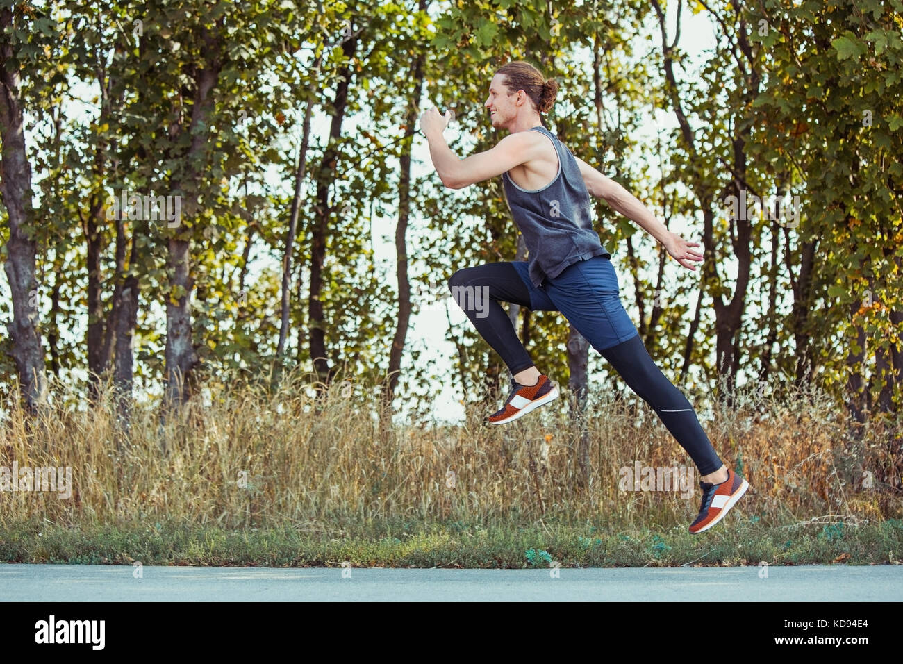 Running sport. Man runner sprinting outdoor in scenic nature. Fit ...