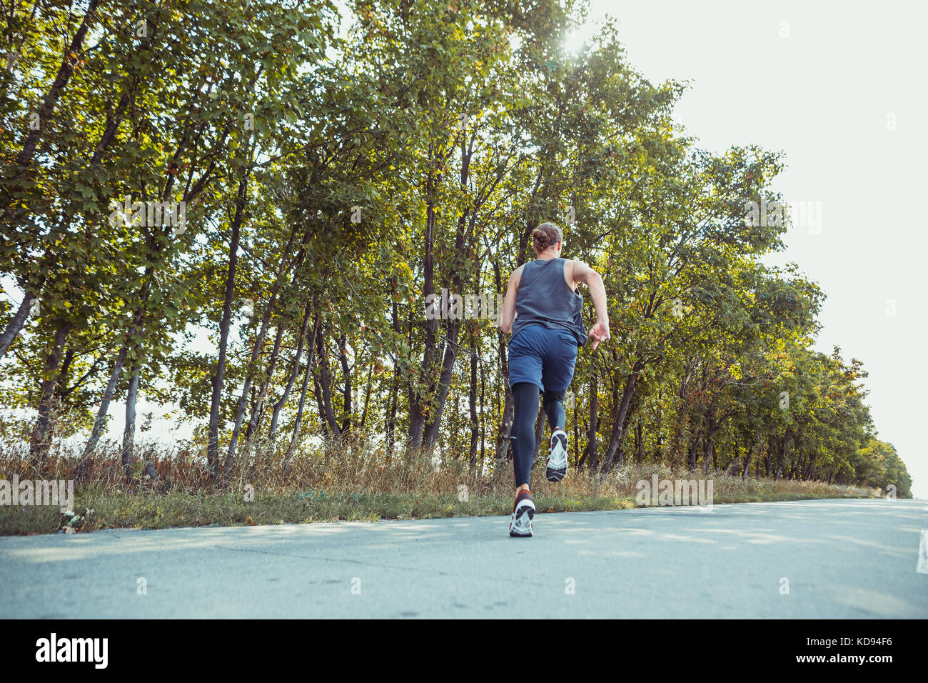 Running sport. Man runner sprinting outdoor in scenic nature. Fit ...