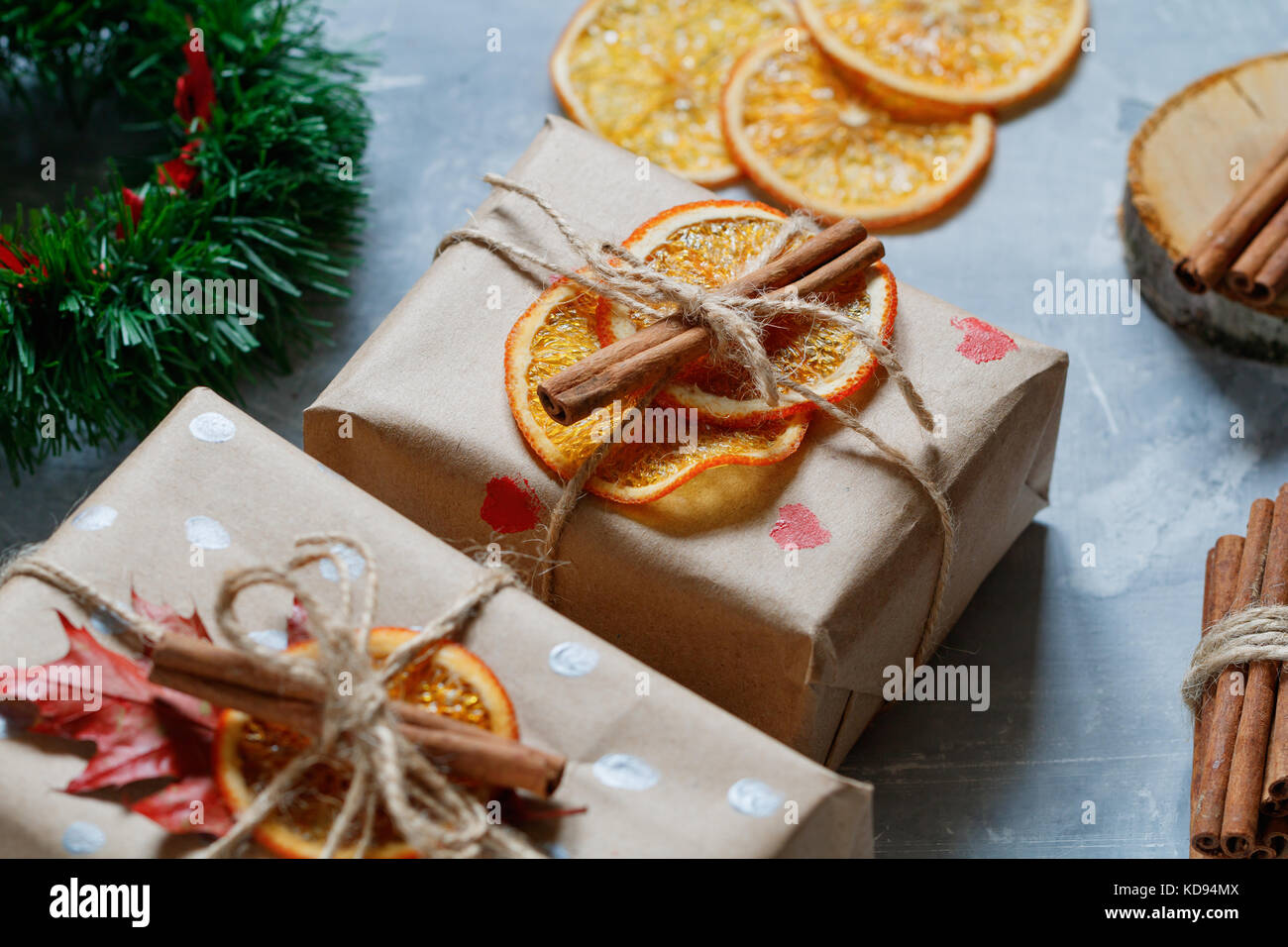 View of christmas gift boxes in a kraft paper decorated dried orange ...
