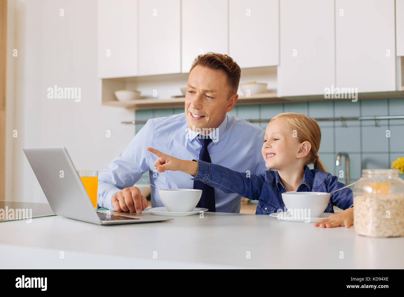 Happy pretty girl pointing at the laptop screen Stock Photo - Alamy