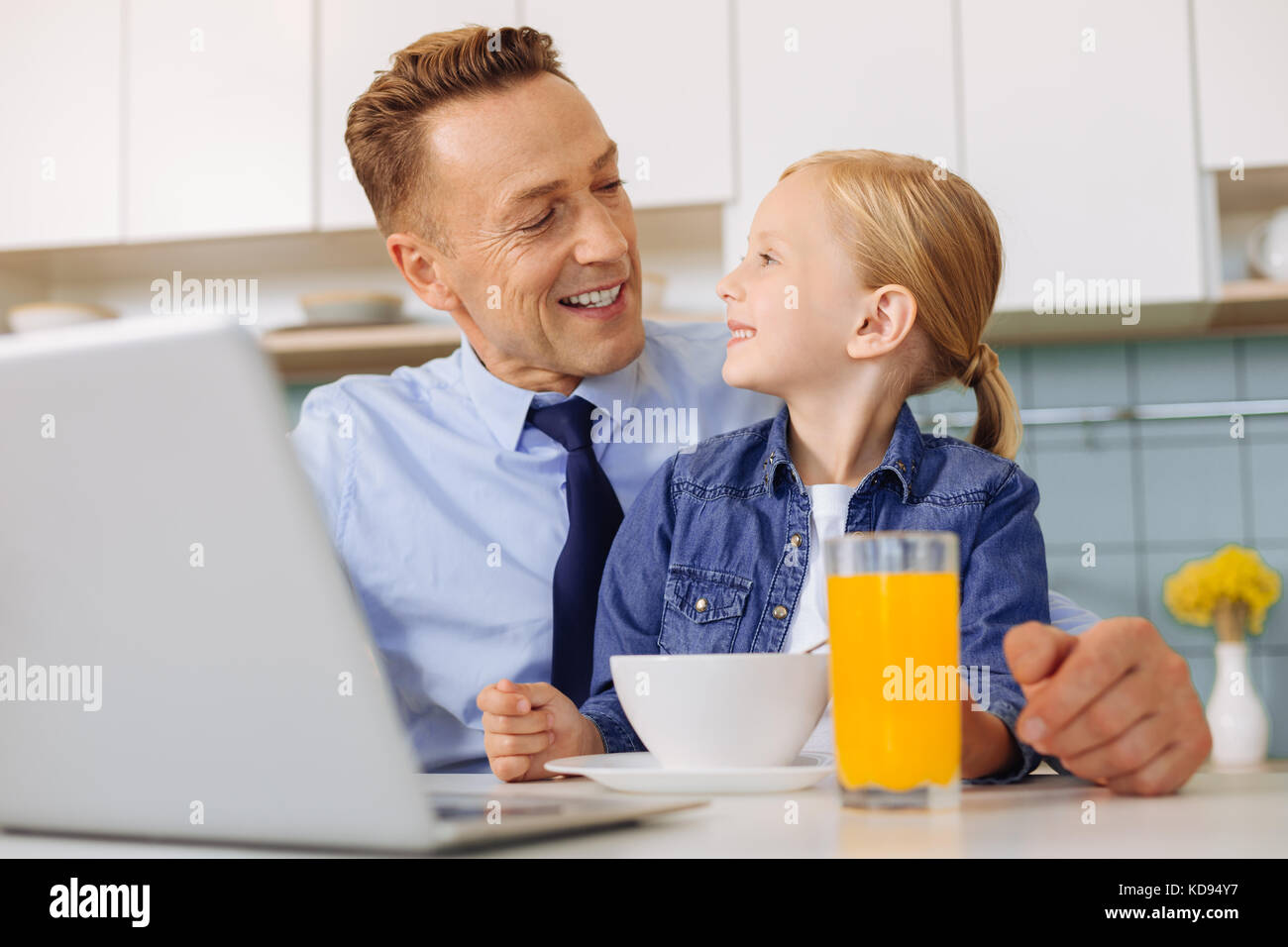 Cheerful nice man looking at his child Stock Photo - Alamy