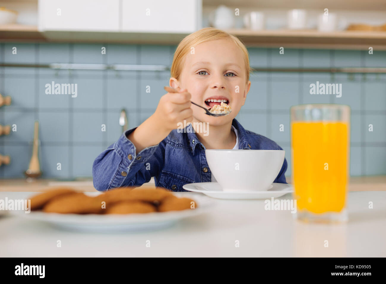 Cute kid holding spoon hi-res stock photography and images - Alamy
